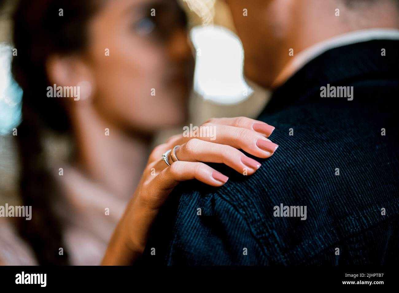 Female hand with engagement ring. Young wife hugs her husband's ...