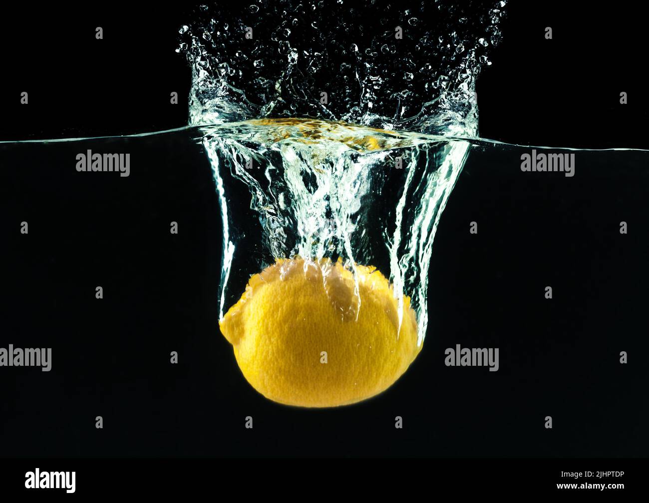 fresh yellow lemon in water splash on black background Stock Photo - Alamy