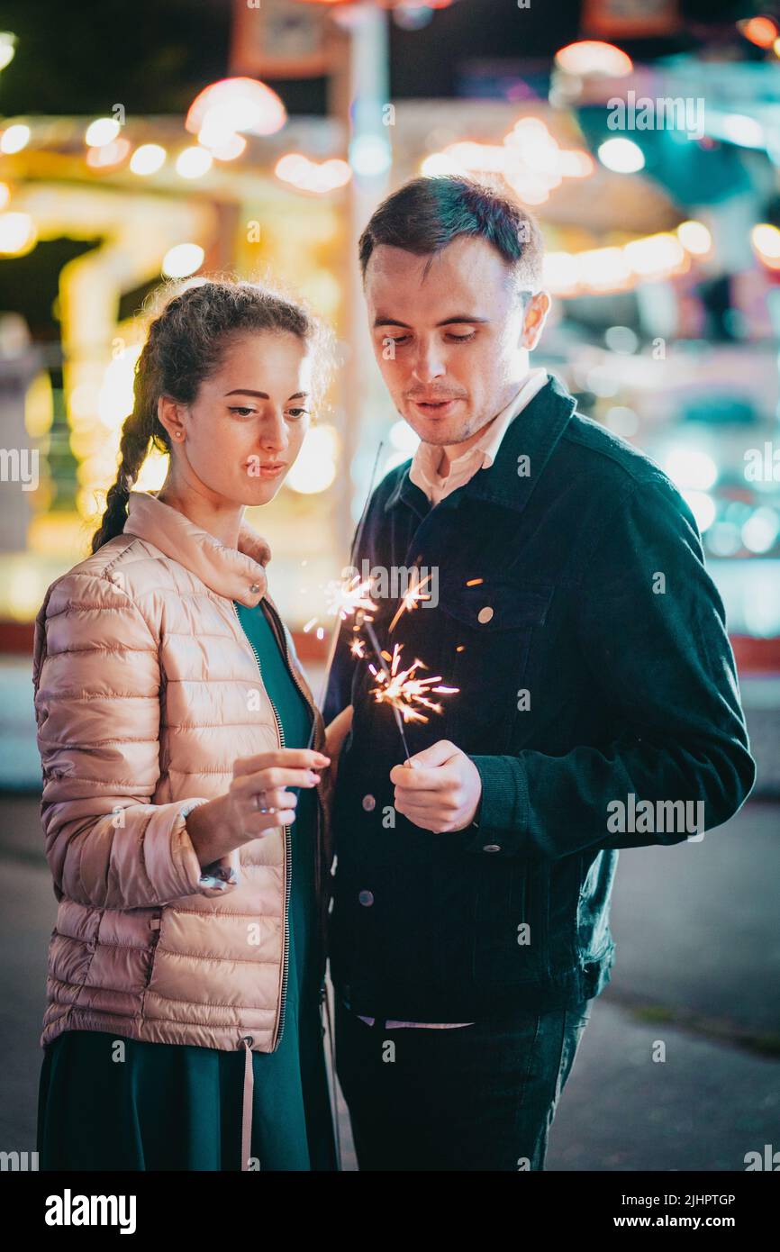 Millennial couple with sparkling bengal fire spending time together on ...
