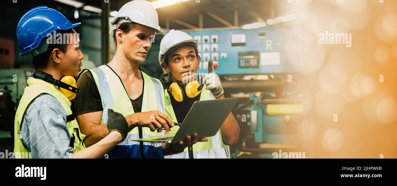 Engineer team working and checking by laptop with engine in industry ...