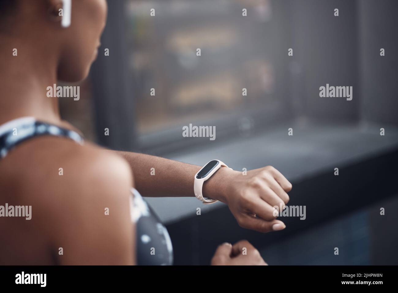 Closeup of one mixed race woman checking time on digital wristwatch ... Closeup of one mixed race woman checking time on digital wristwatch ...