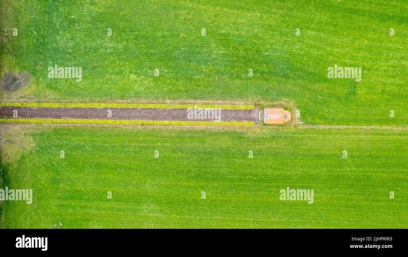 garden detail in aerial view with sand path going between two hedges ...