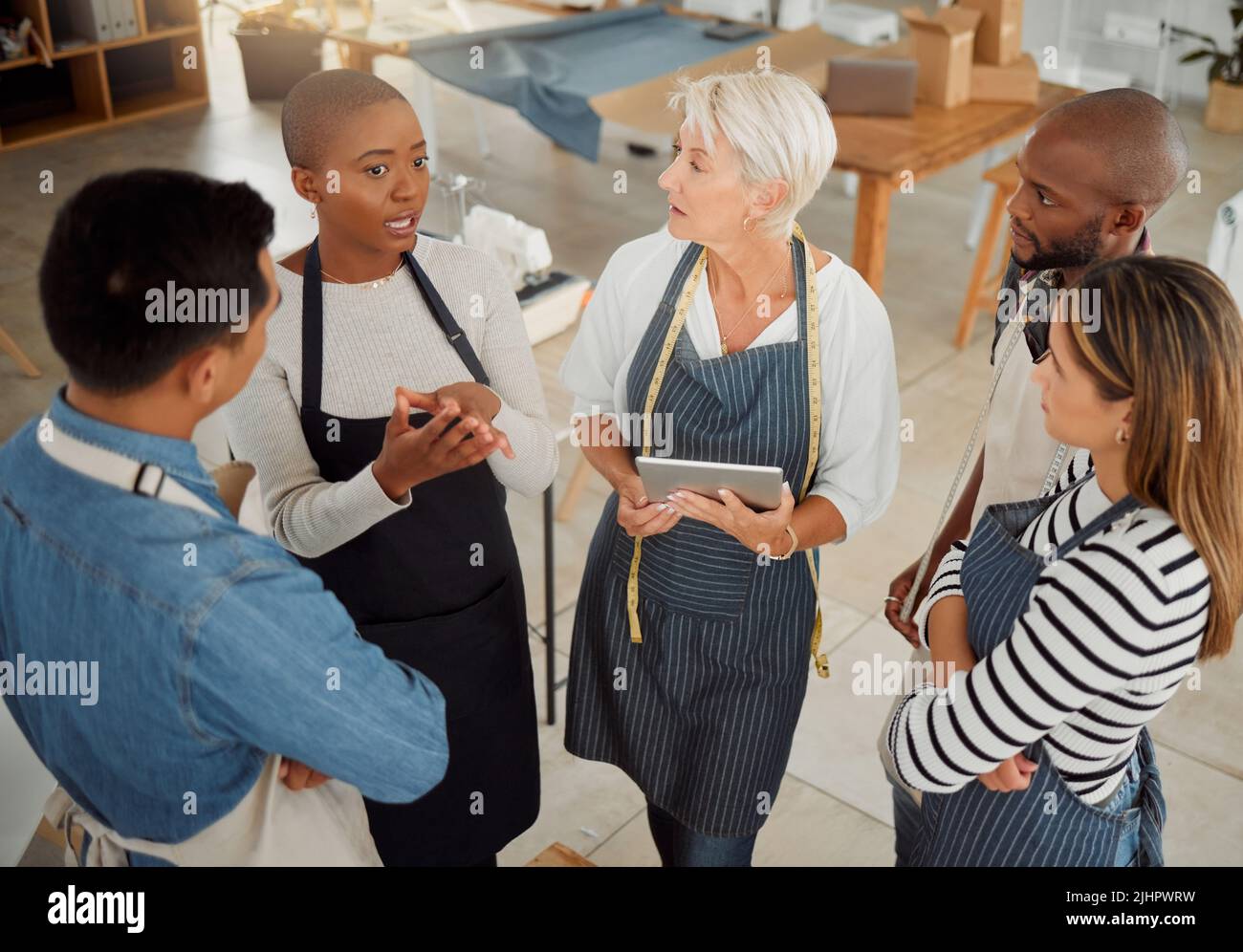 Group of five diverse creative designers having a meeting while ...