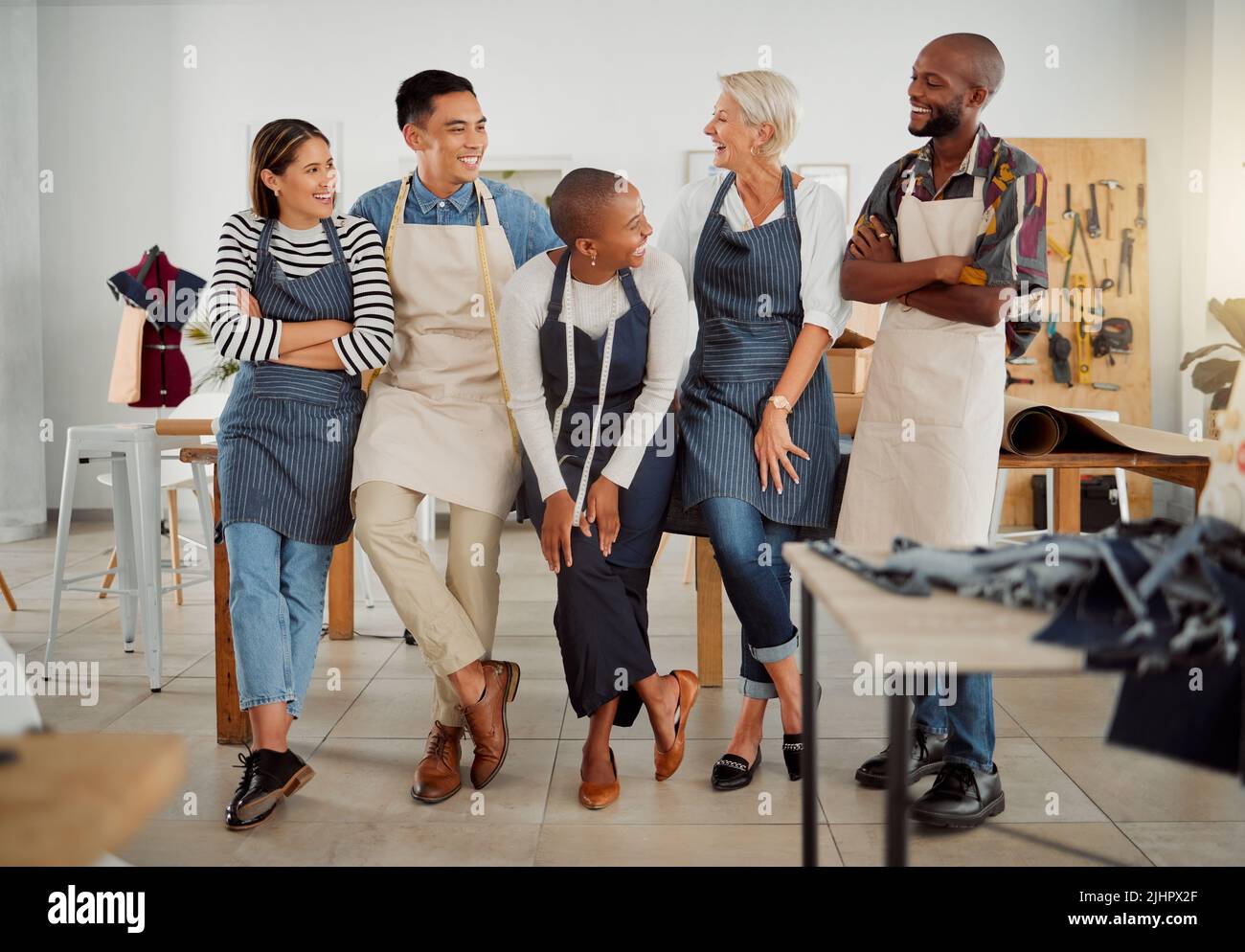 Group of five cheerful diverse clothing designers standing with their ...