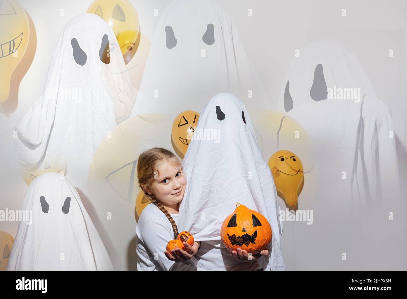 Happy Halloween. Double composition with photos of girl hugging ghost ...