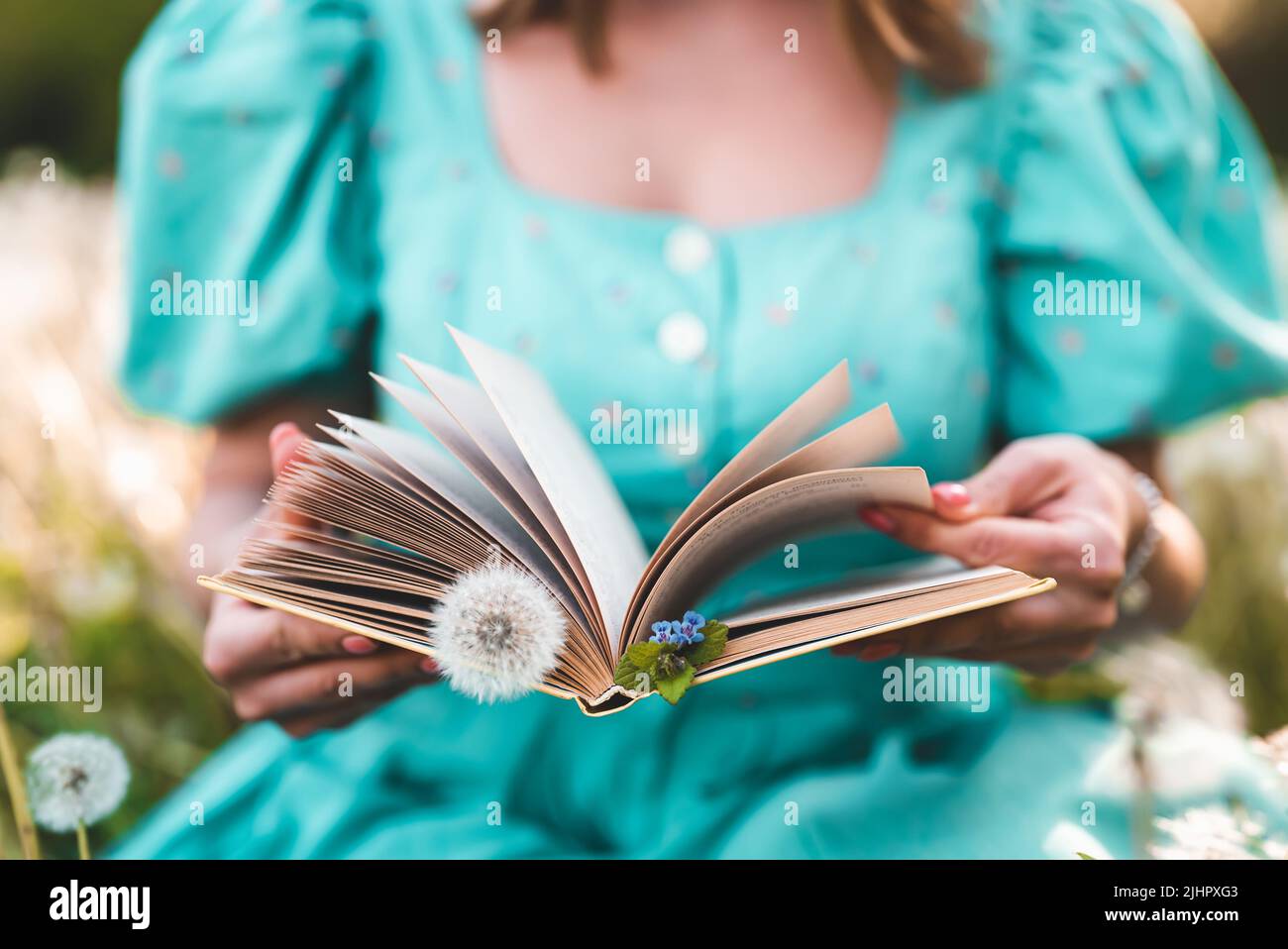 Hands of woman turns over pages of old paper book. Lady in retro or ...