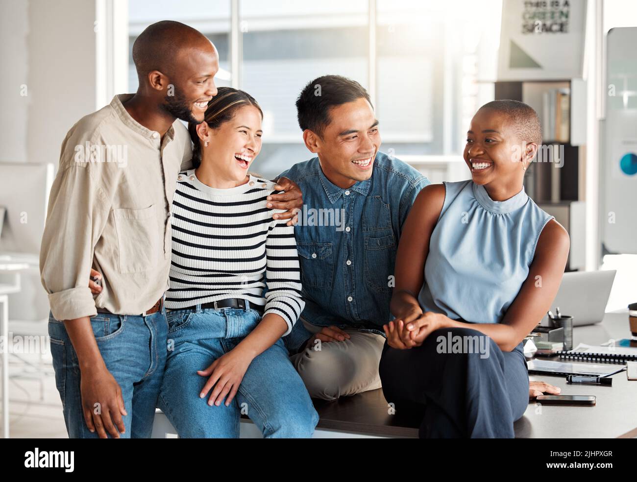 Group of diverse cheerful businesspeople spending time in an office ...