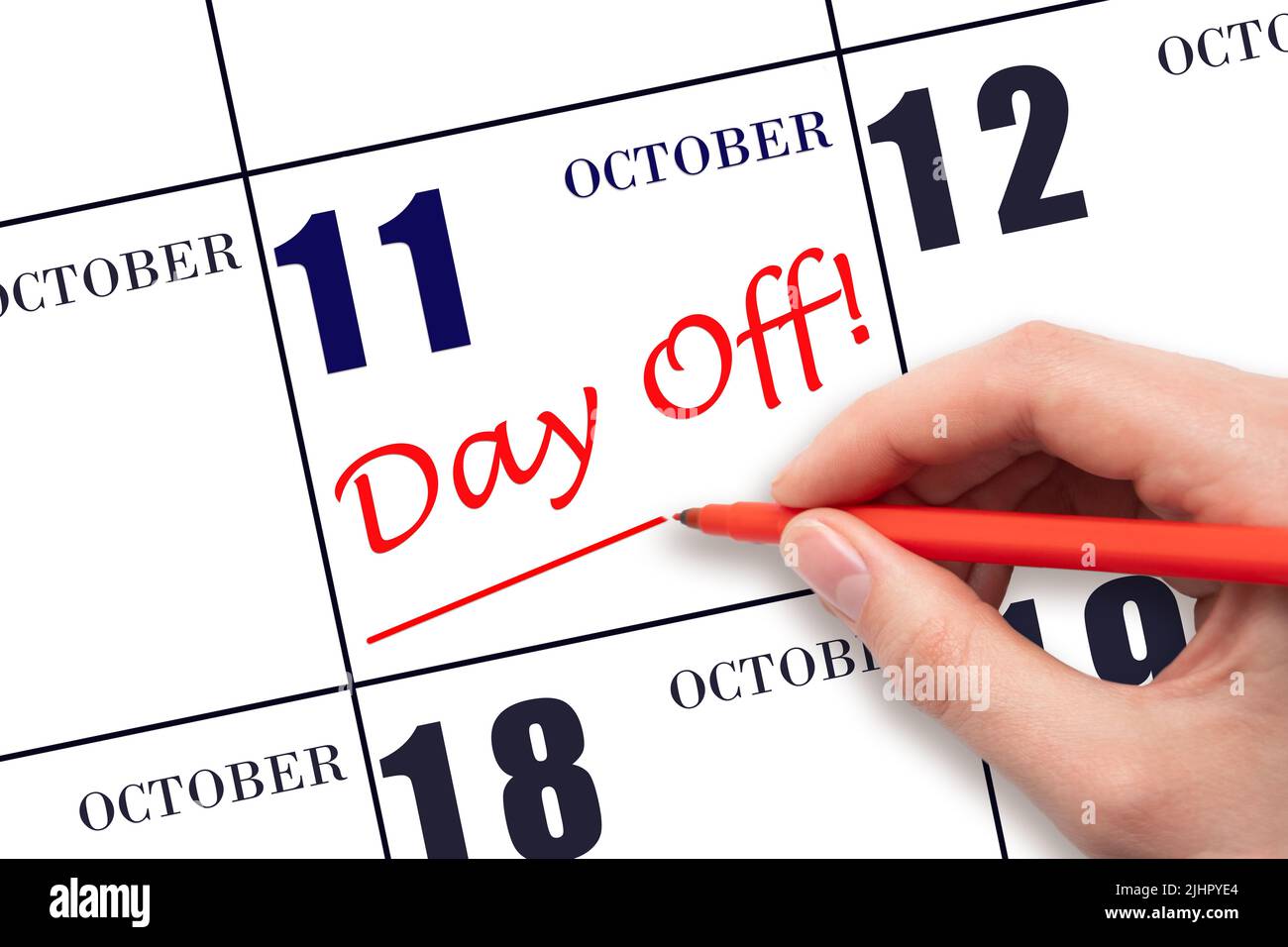 11th day of October. Hand writing text DAY OFF and drawing a line on ...