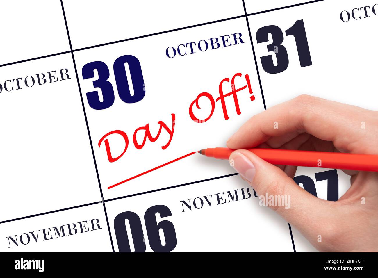 30th day of October. Hand writing text DAY OFF and drawing a line on ...