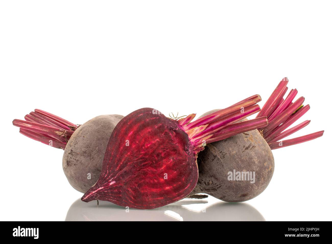 One half and two whole red beets, close-up, isolated on a white ...