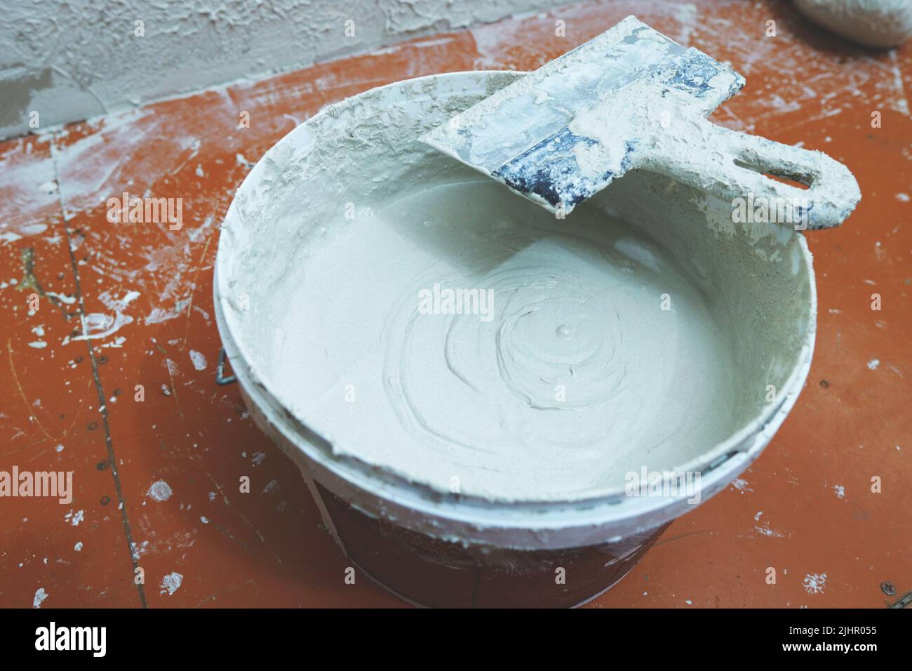 bucket with plaster and spatula, interior repair and wall alignment ...