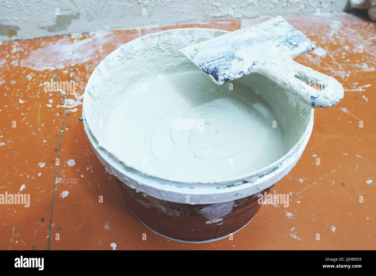 bucket with plaster and spatula, interior repair and wall alignment ...
