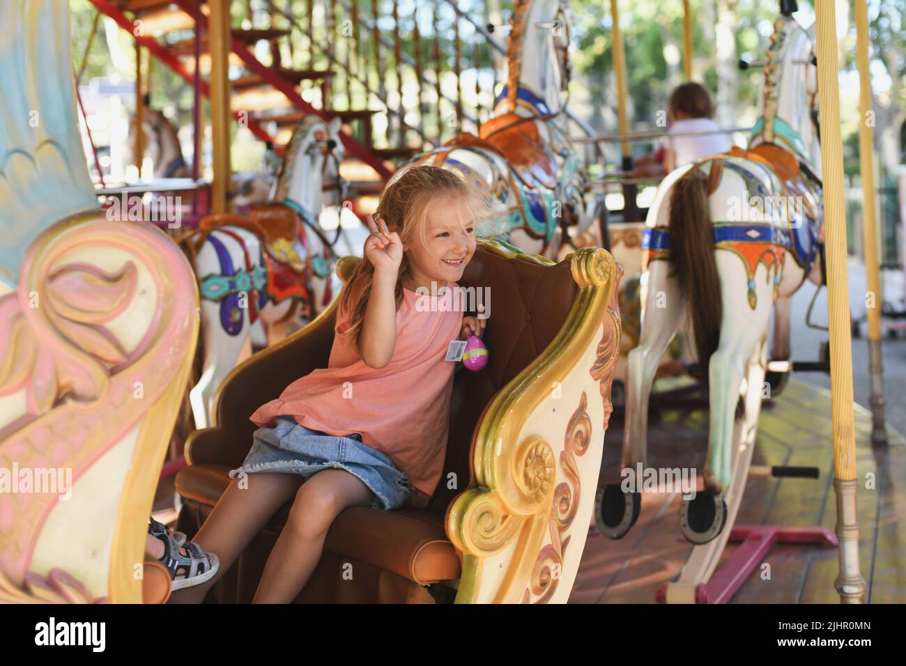 Girl on the carousel.Horses on a carnival Merry Go Round.Carousel Stock ...