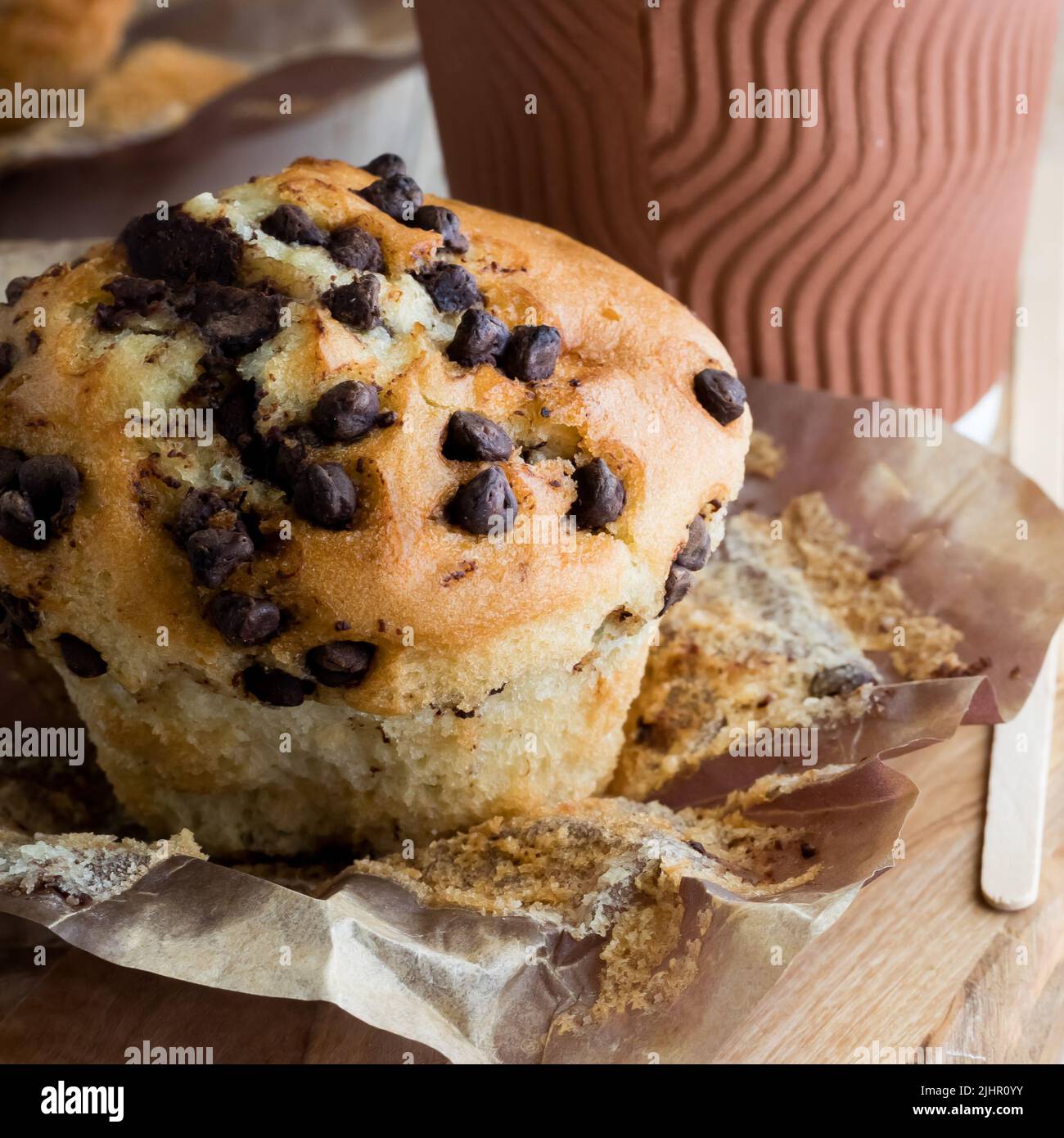 A chocolate chip muffin in a paper wrapper, ready for eating Stock ...