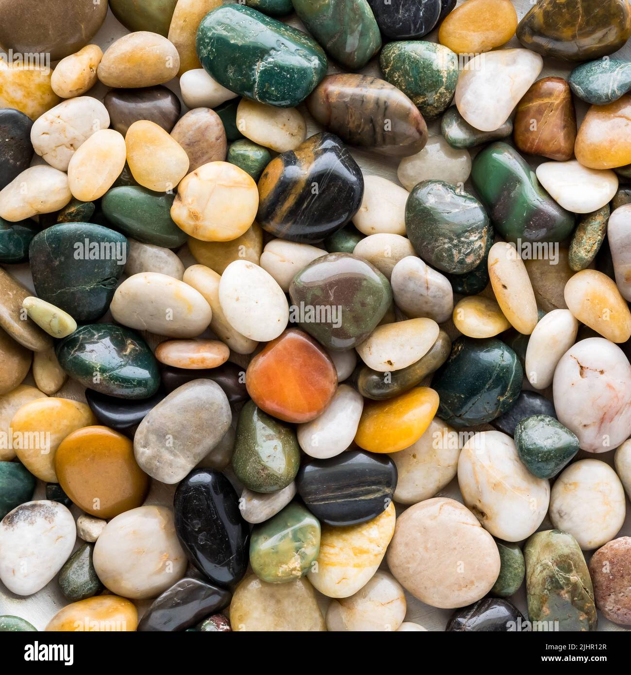 Top down view of polished river rock pebbles. Square crop Stock Photo ...