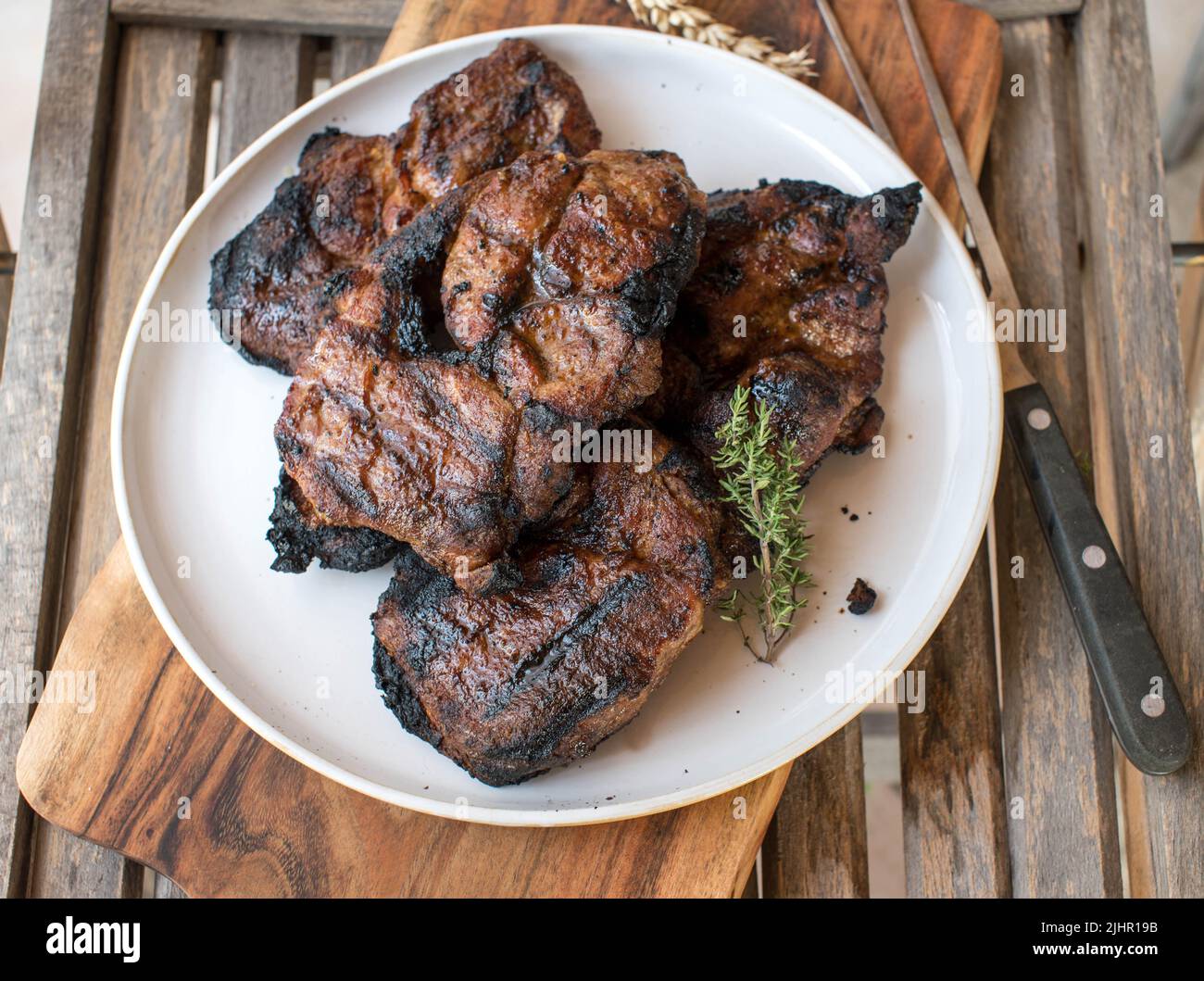 Fresh grilled pork neck steaks on a plate Stock Photo - Alamy