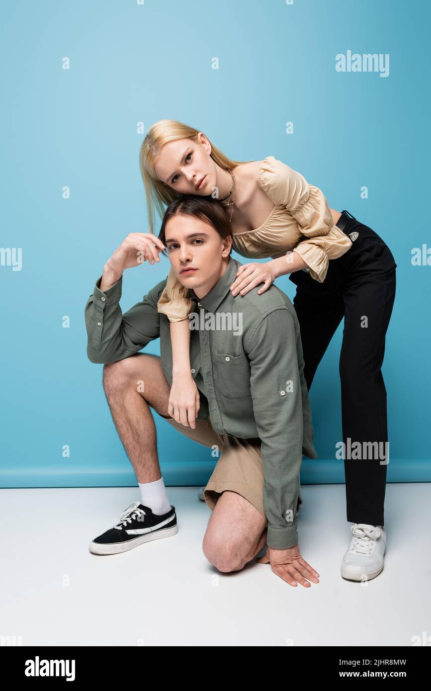 Stylish young models looking at camera on blue background Stock Photo ...