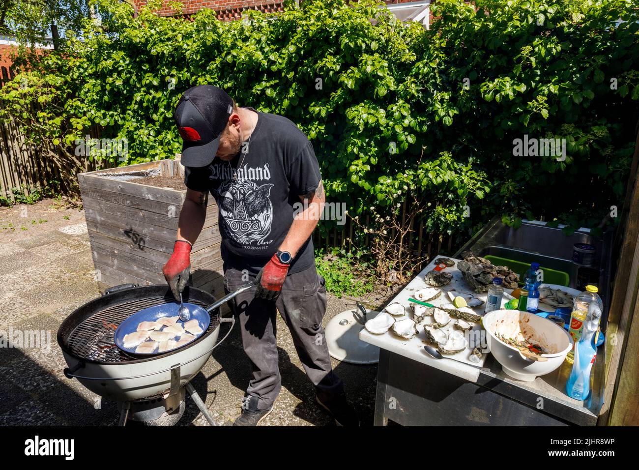 Outdoor cooking with zander fillets in the pan on the charcoal grill ...