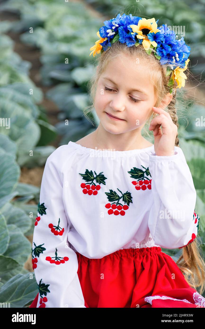 Child girl in traditional Ukrainian vyshyvanka and blue-yellow wreath ...