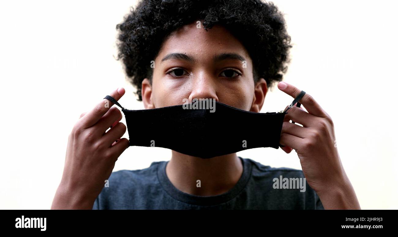 Mixed race kid putting covid-19 face mask on Stock Photo - Alamy