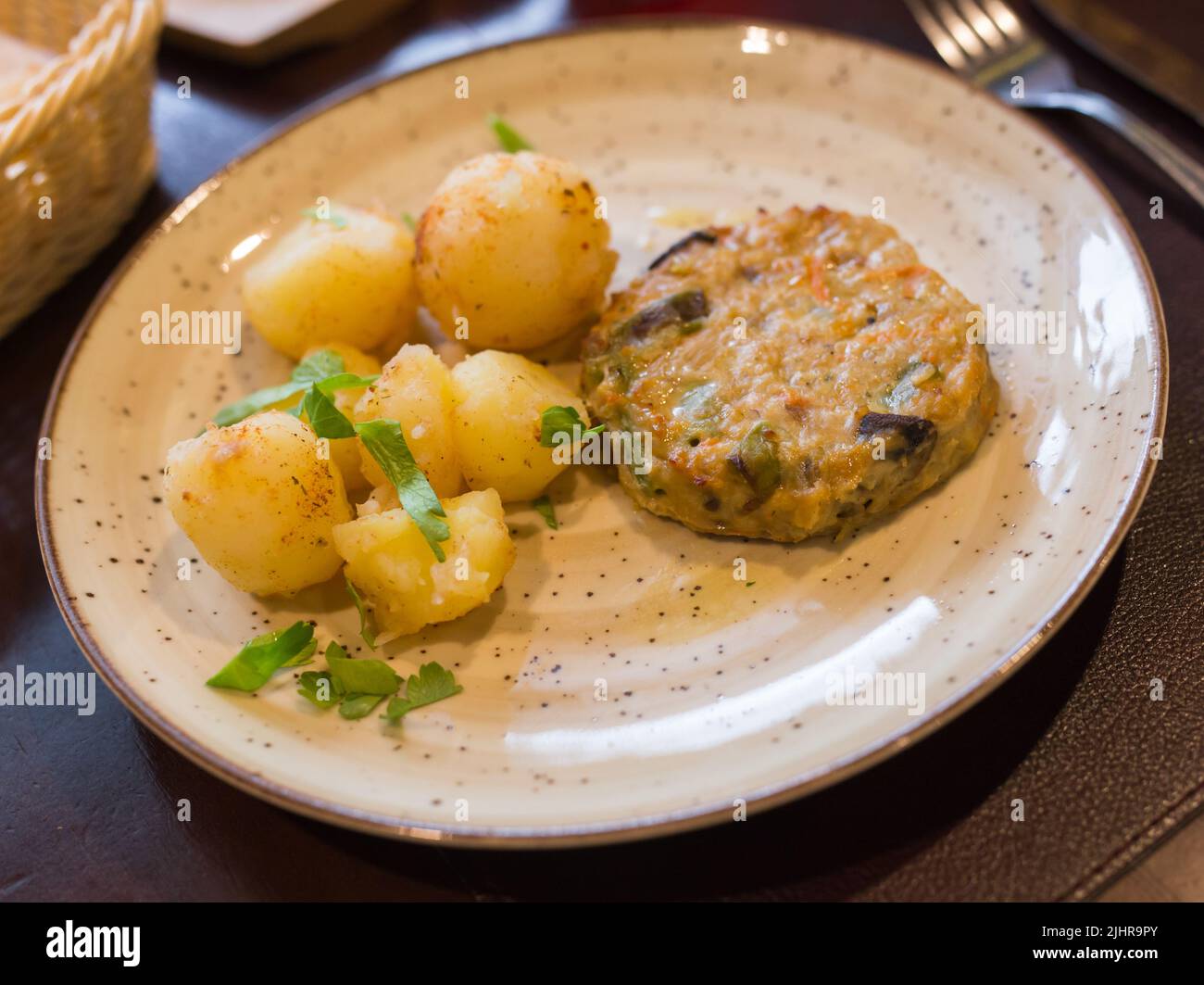 chicken burger with boiled potatoes on plate Stock Photo - Alamy