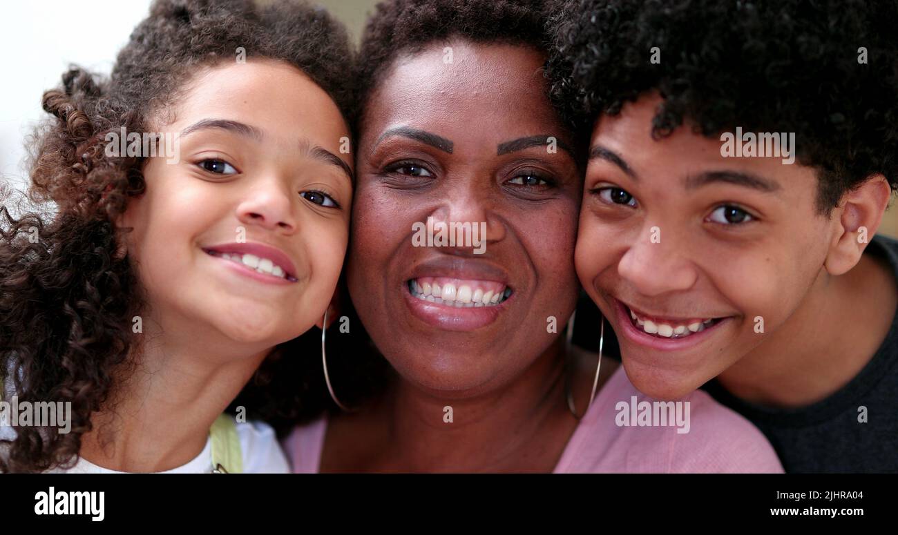 Mixed Race Mother Daughter And Son Faces Smiling At Camera Ethnically