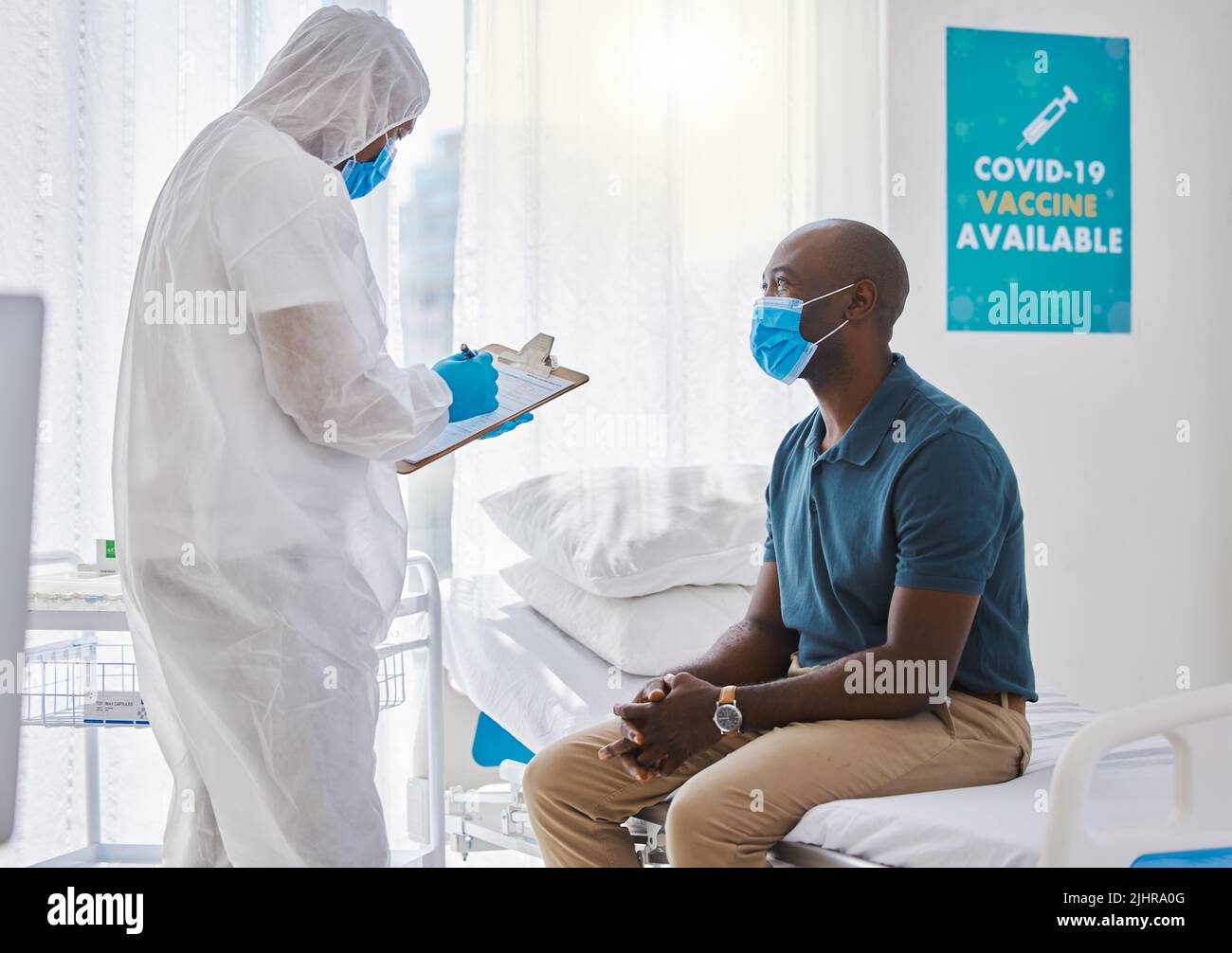 Patient talking to a doctor during a checkup. Specialist writing ...