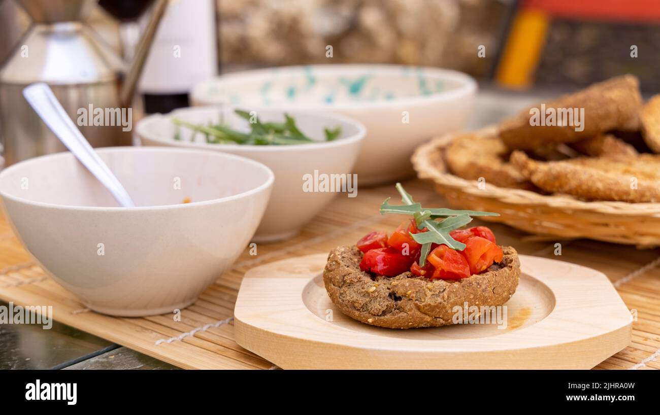 Italian summer appetizer Friselle with cherry tomatoes, oil and rucola ...