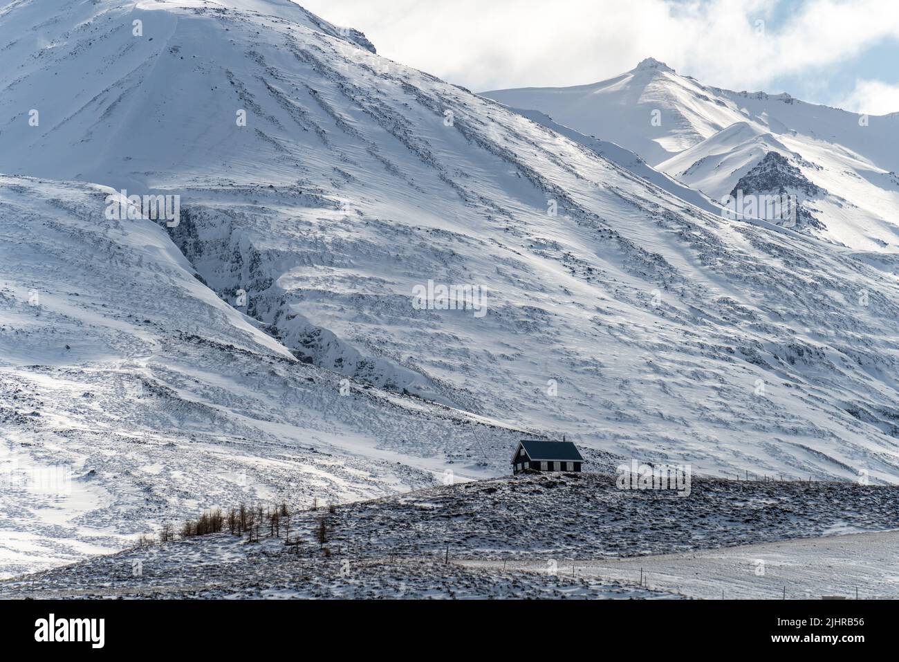A lonely abandoned structure among the mountains in the snow. Winter in ...