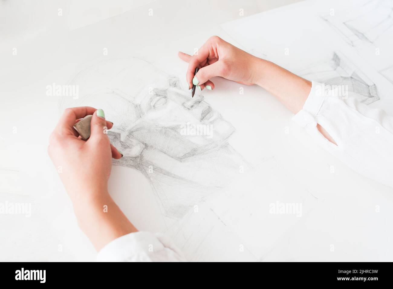 Hands of artist drawing portrait with pencil Stock Photo - Alamy