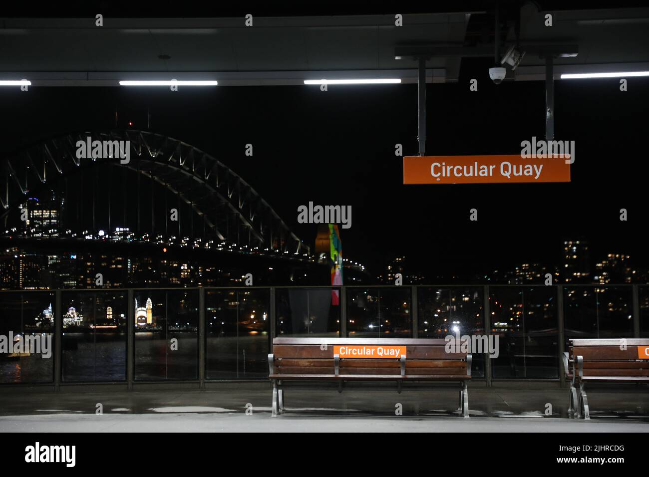 Circular Quay train station at night with the Sydney Harbour Bridge in ...