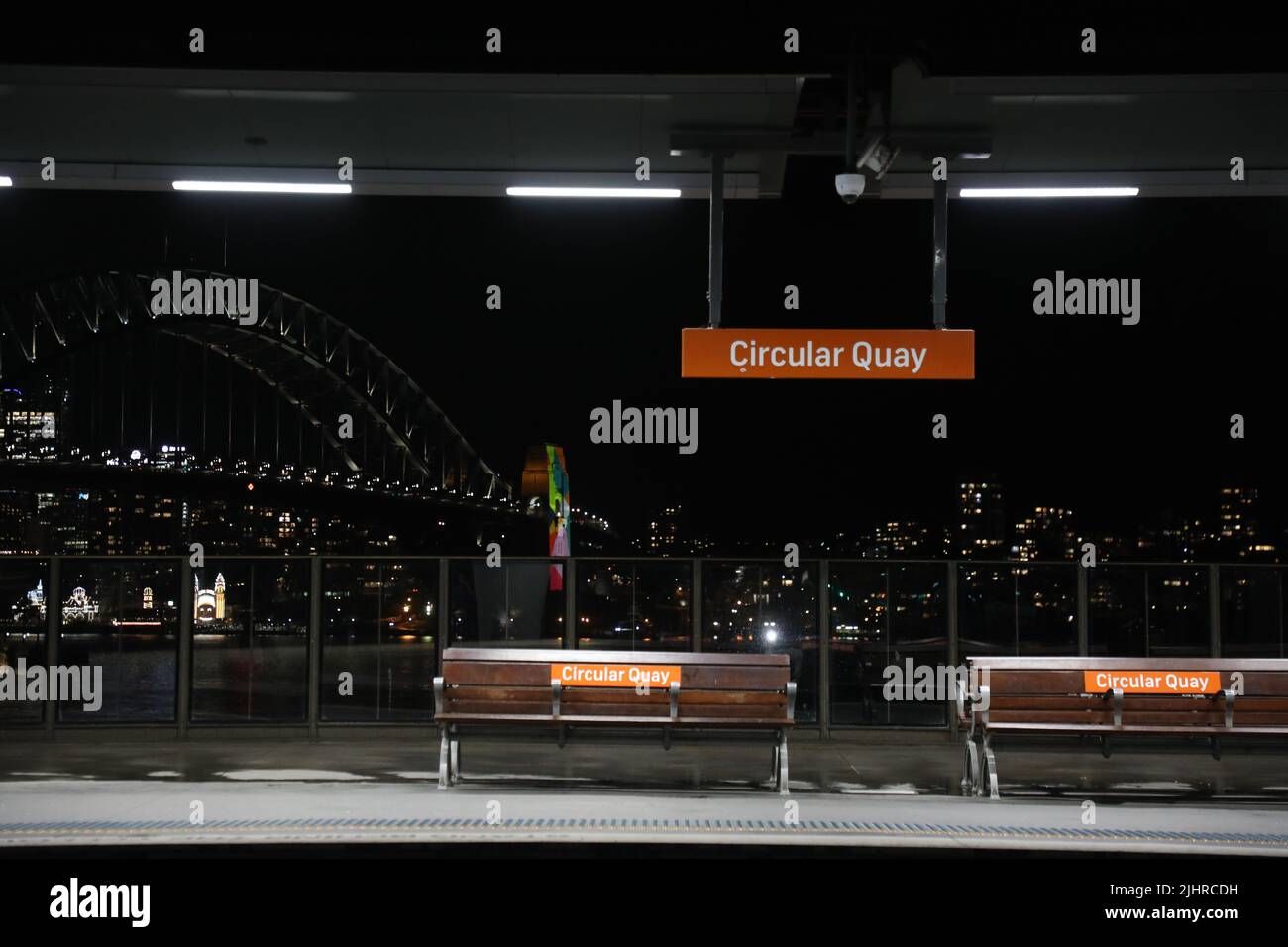 Circular Quay train station at night with the Sydney Harbour Bridge in ...