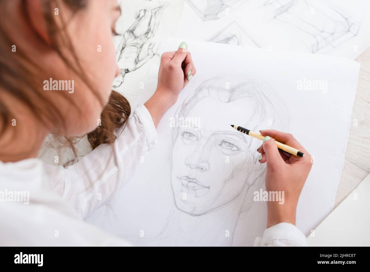 Artist drawing pencil portrait close-up Stock Photo - Alamy