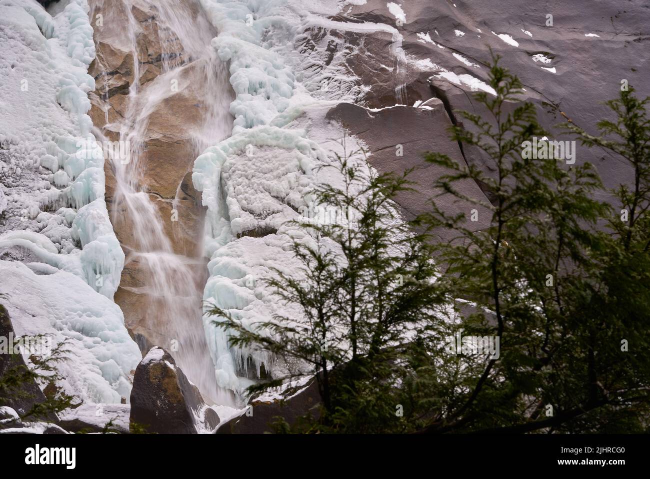 Waterfall Cliff Ice. A winter cliff coated in ice as a waterfall roars ...
