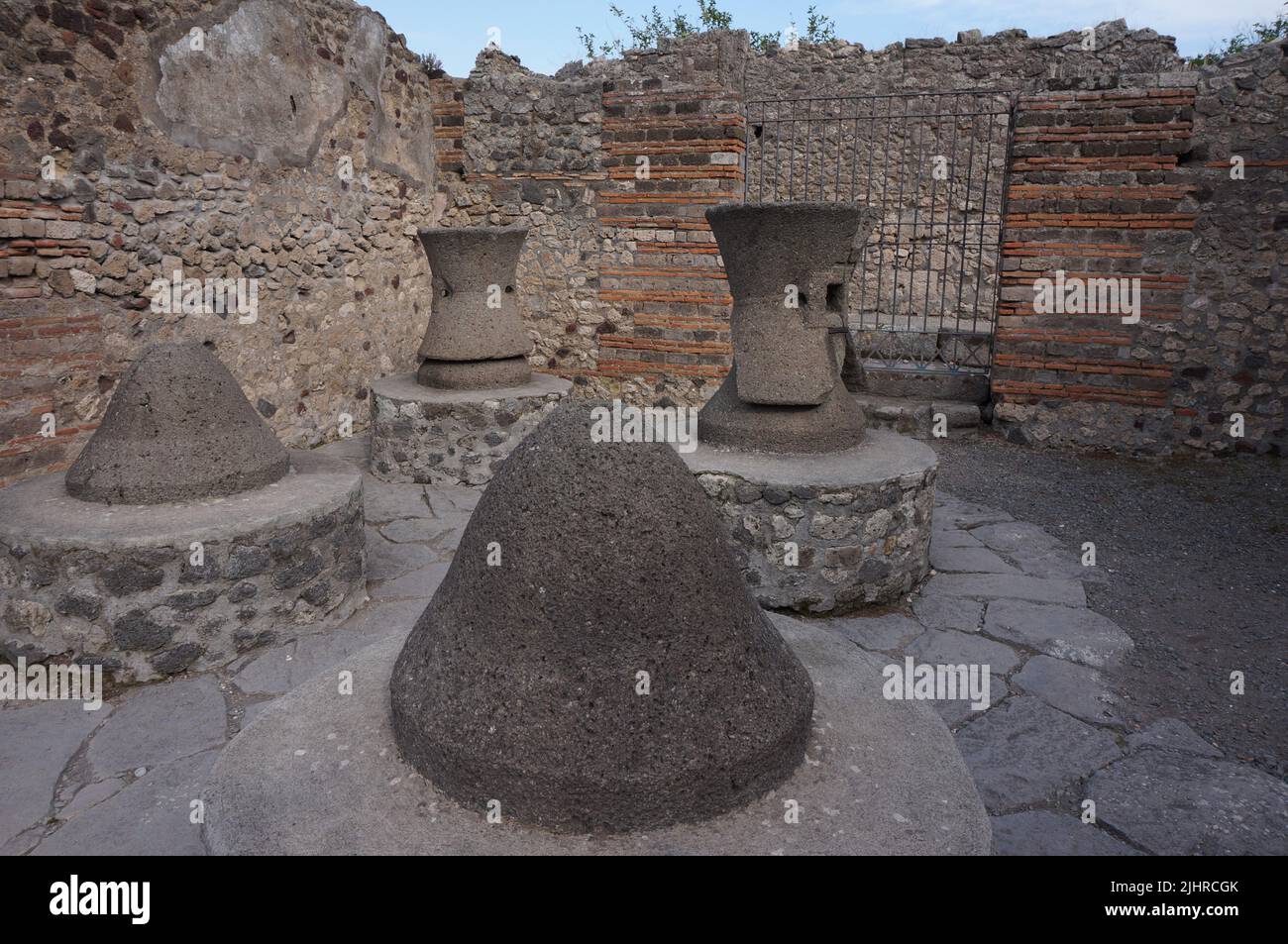 Grinding stones at Pompei ancient mill Stock Photo - Alamy