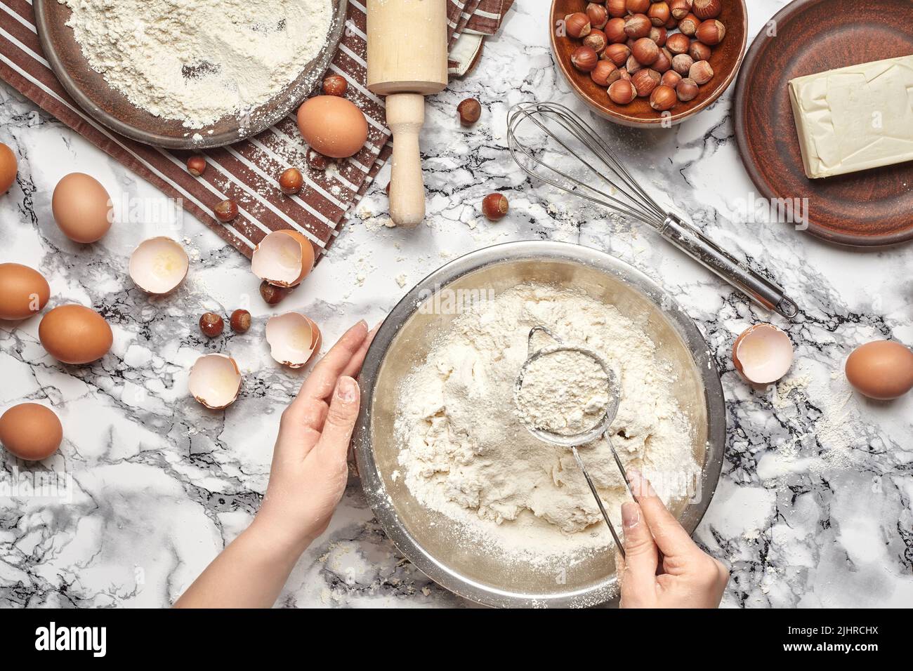 Close-up shot. Top view of a baker cook place, hands are working with a ...