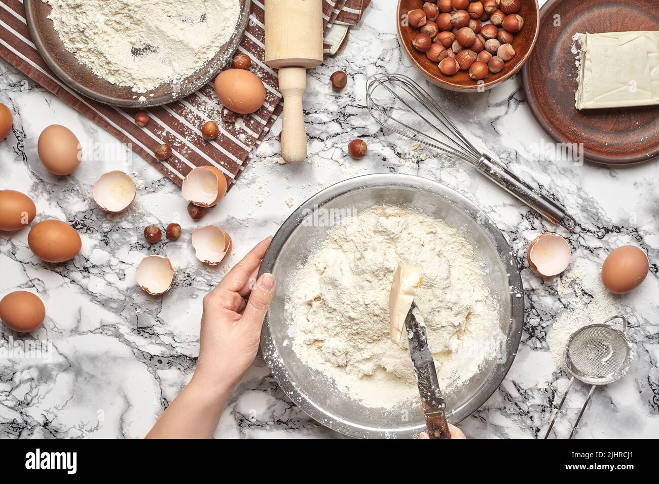 Close-up shot. Top view of a baker cook place, hands are working with a ...