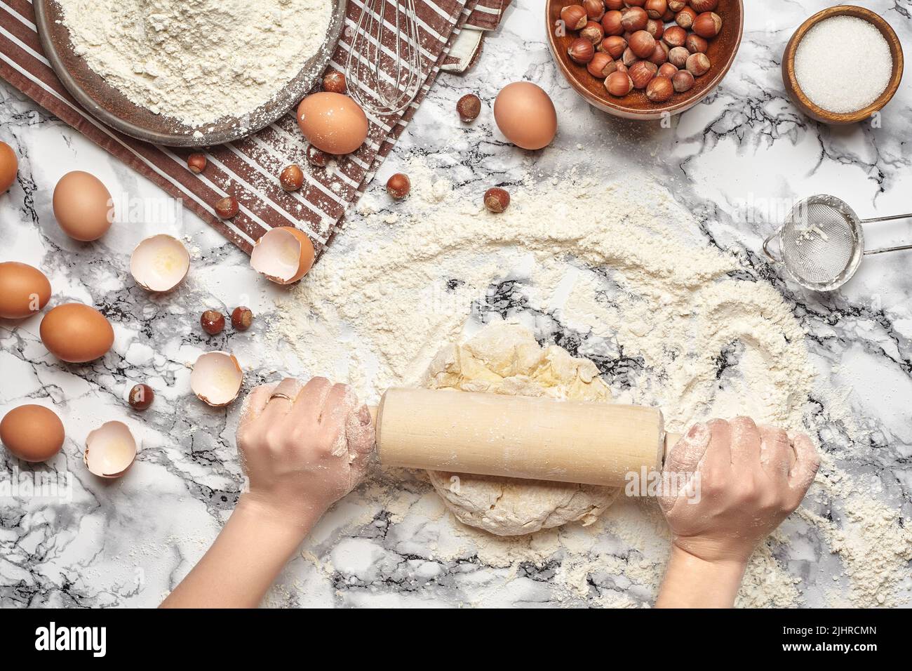 Close-up shot. Top view of a baker cook place, hands are working with a ...