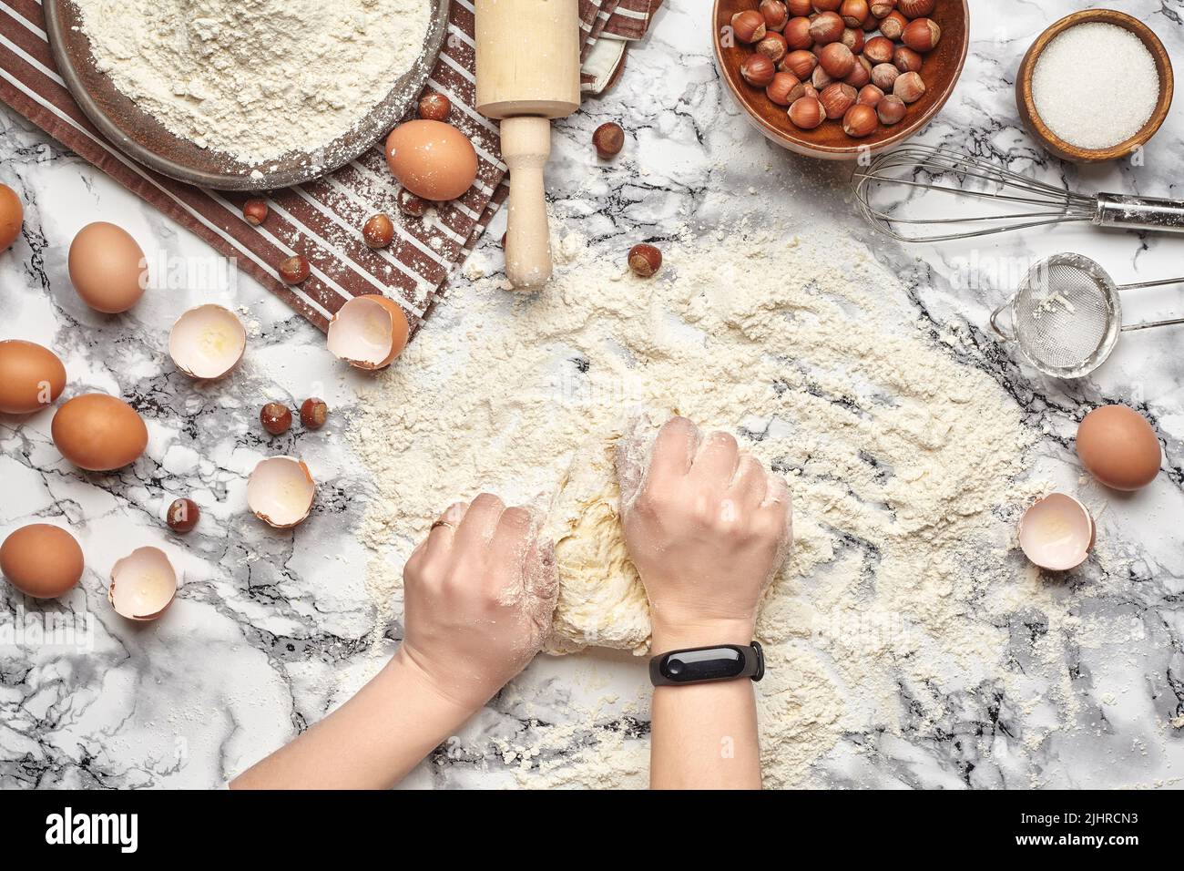 Close-up shot. Top view of a baker cook place, hands are working with a ...