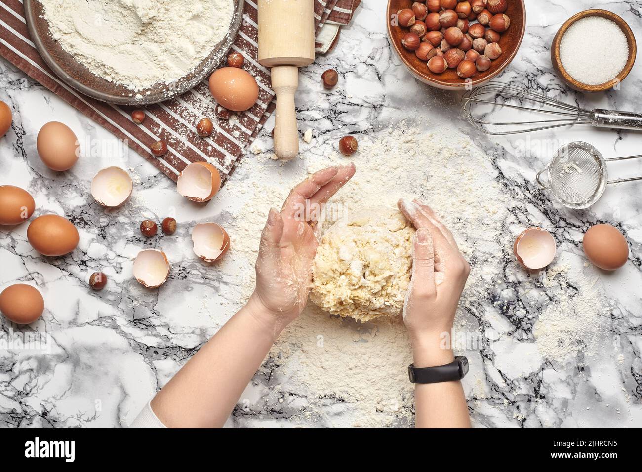 Close-up shot. Top view of a baker cook place, hands are working with a ...