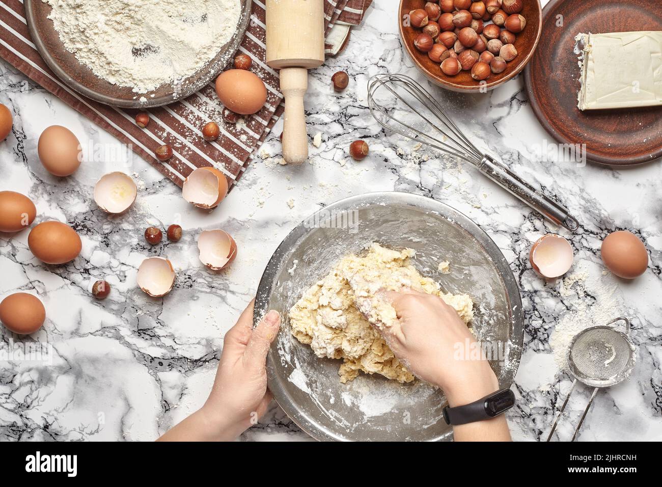 Close-up shot. Top view of a baker cook place, hands are working with a ...