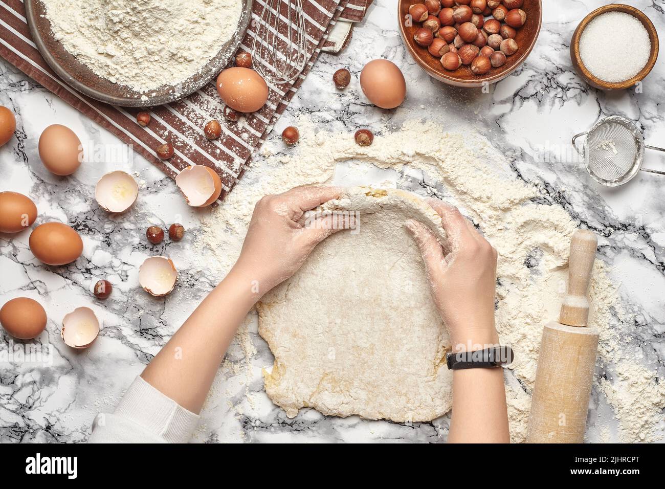 Close-up shot. Top view of a baker cook place, hands are working with a ...