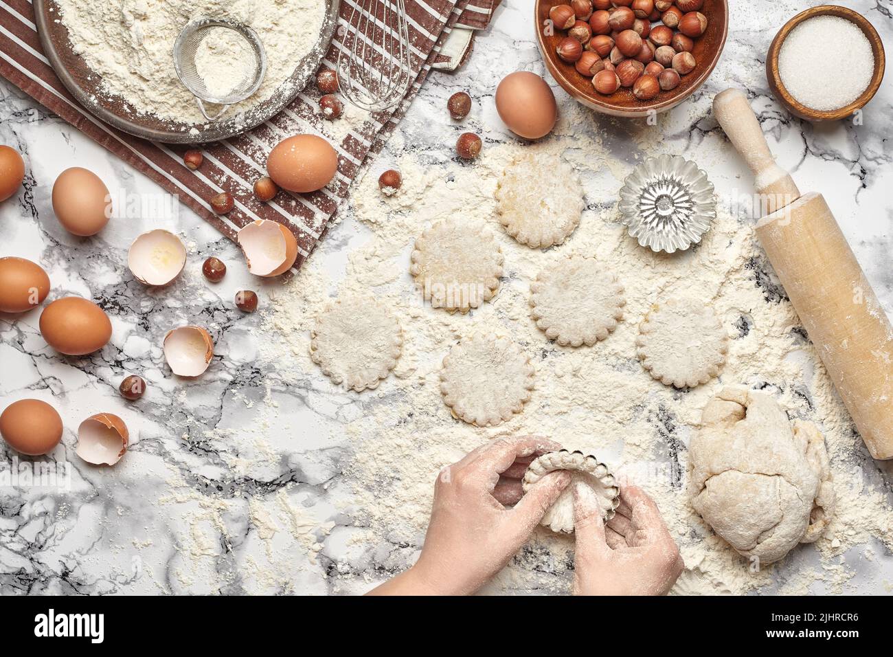 Close-up shot. Top view of a baker cook place, hands are working with a ...