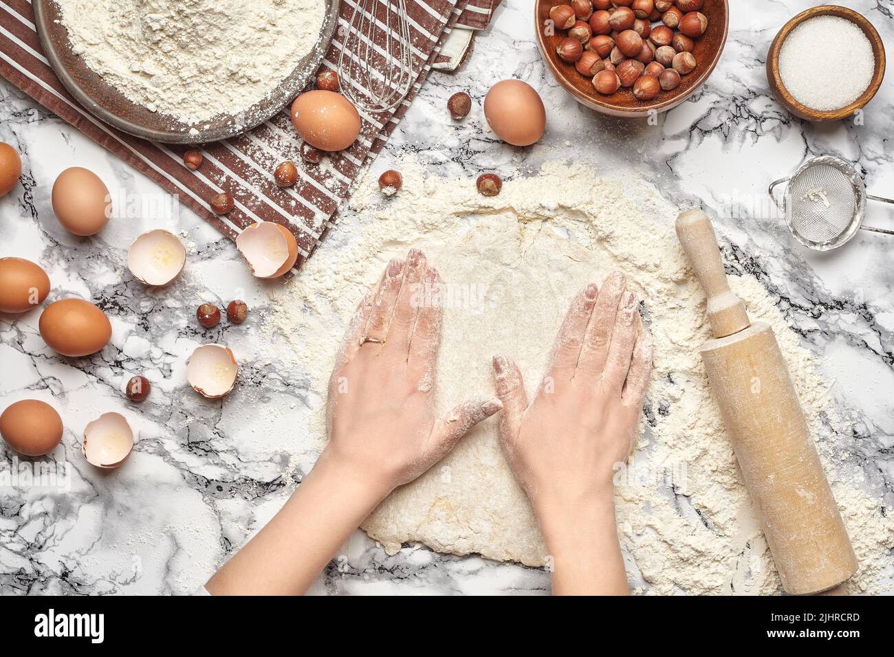 Close-up shot. Top view of a baker cook place, hands are working with a ...