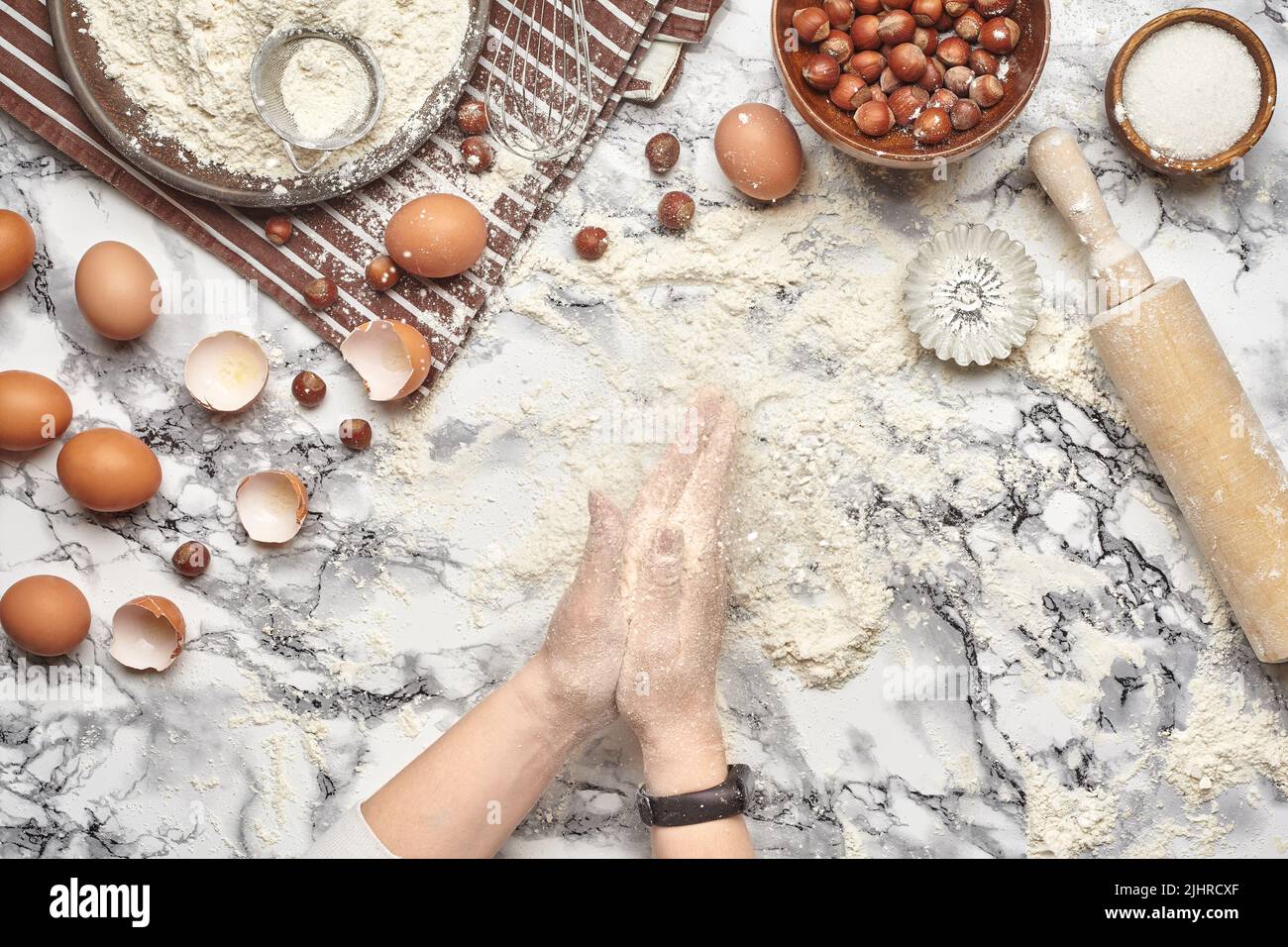 Close-up shot. Top view of a baker cook place, hands are working with a ...