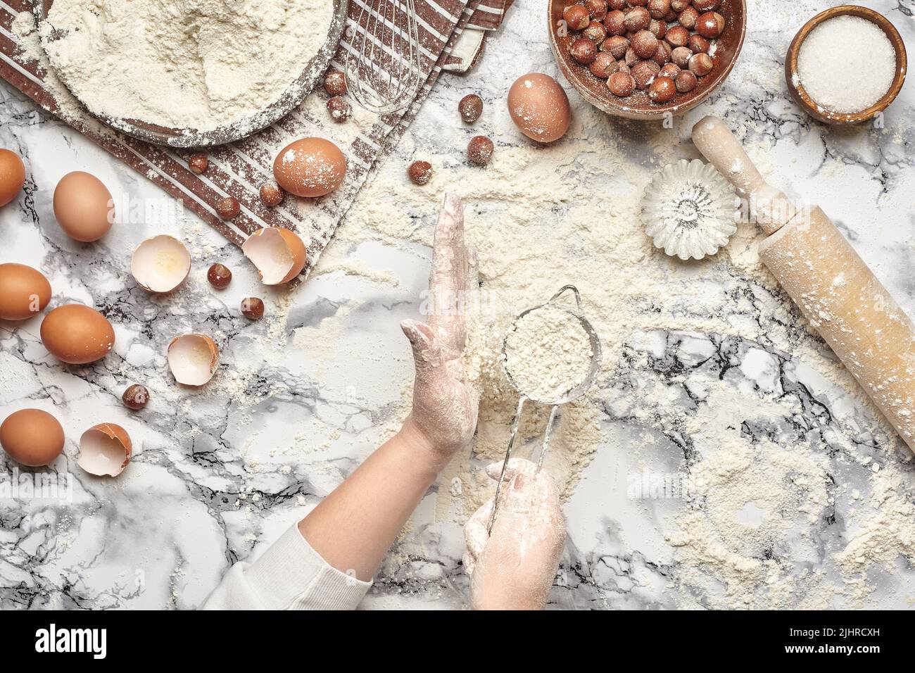 Close-up shot. Top view of a baker cook place, hands are working with a ...