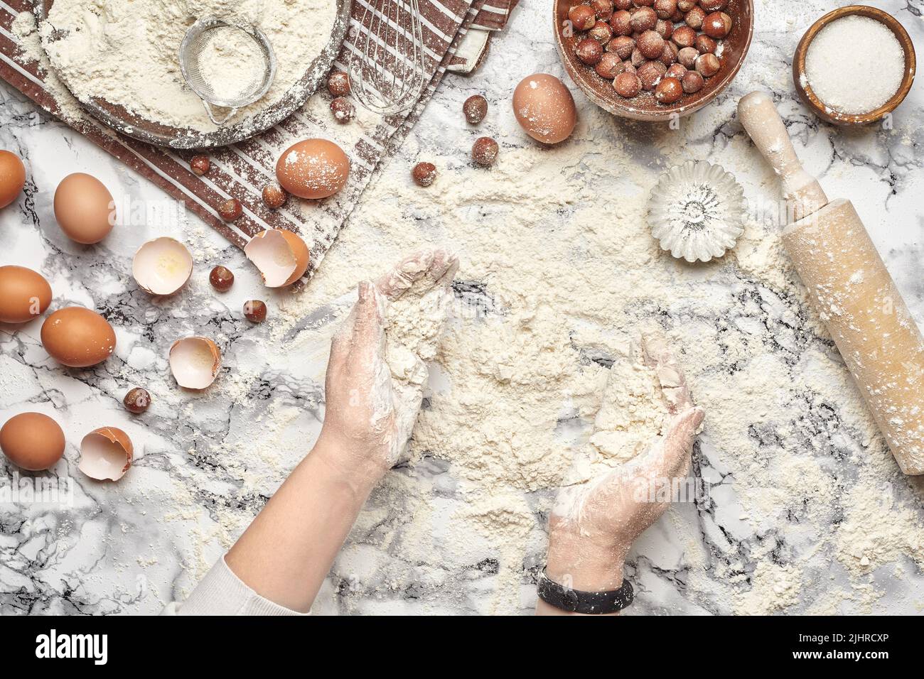 Close-up shot. Top view of a baker cook place, hands are working with a ...