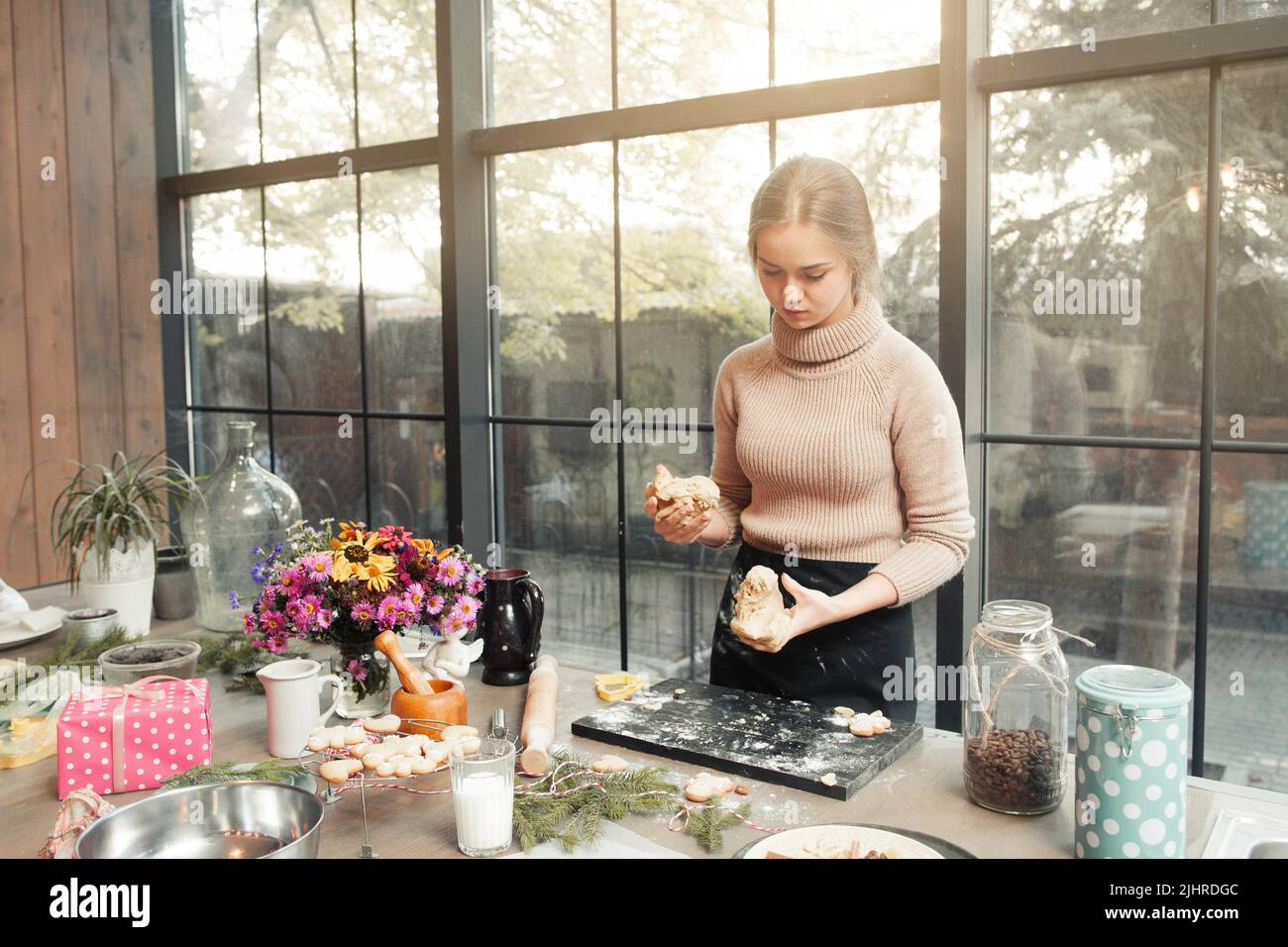 Young woman cooking at kitchen Stock Photo - Alamy