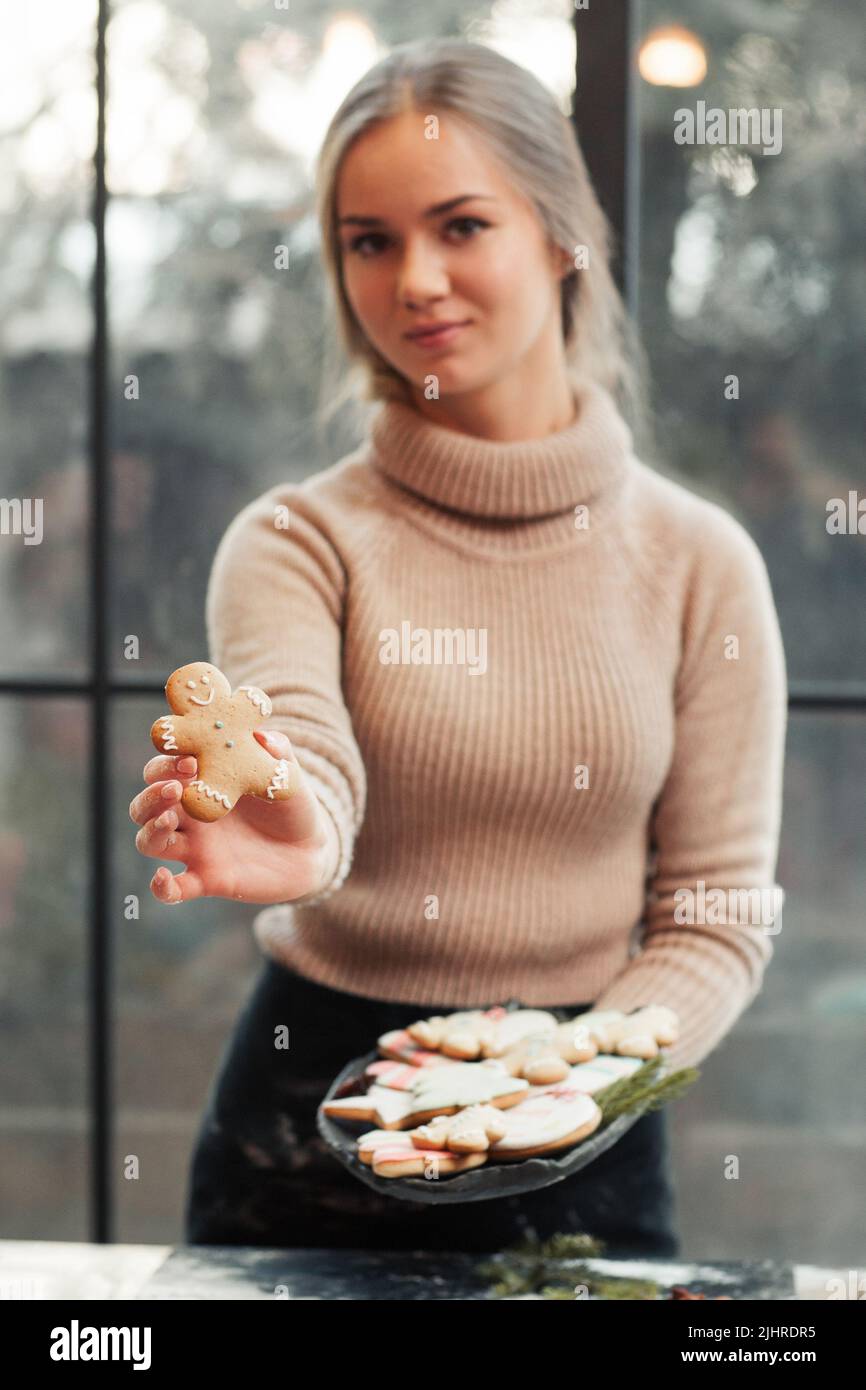 Woman eating gingerbread man hi-res stock photography and images - Alamy