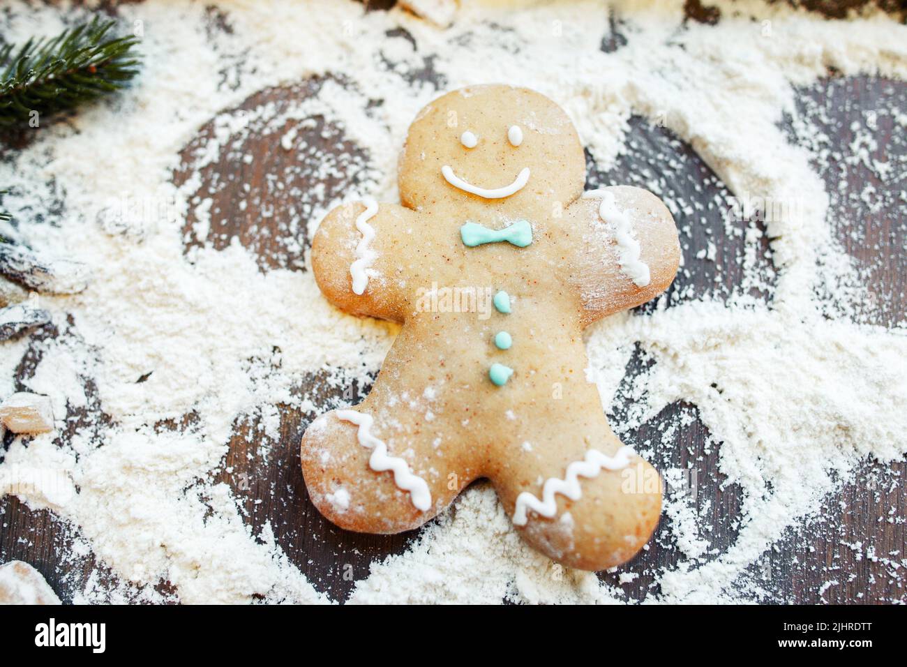 Gingerbread man making snow angel on flour Stock Photo - Alamy